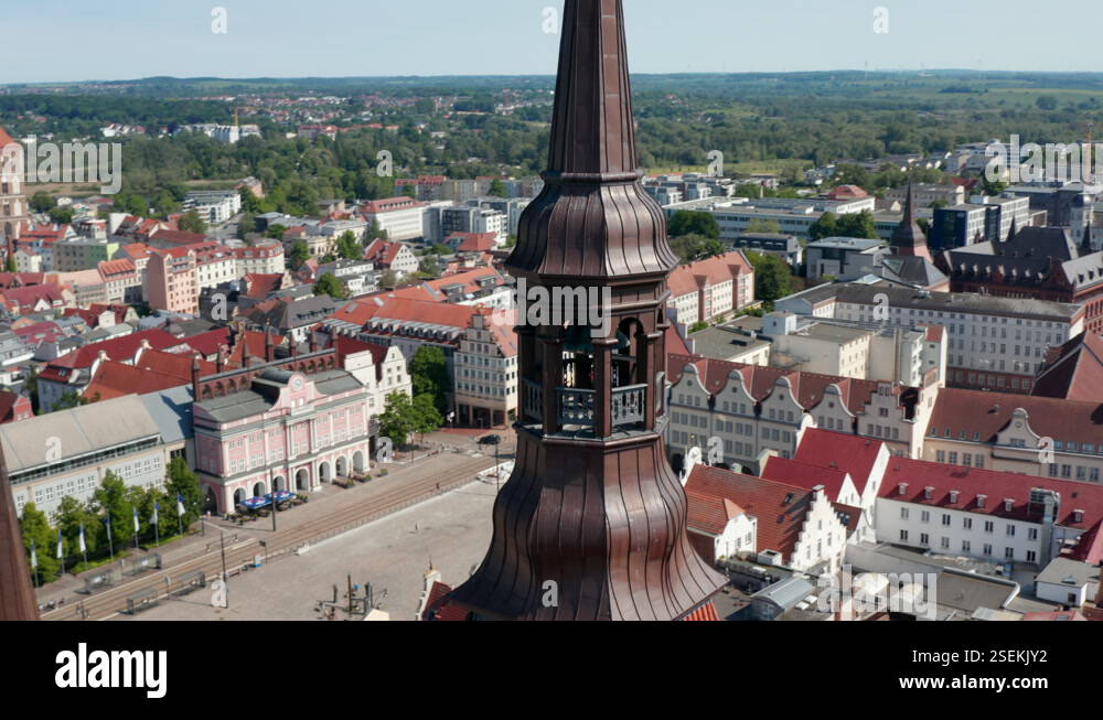 Pan and tilt down footage of church tower and historic city centre with ...