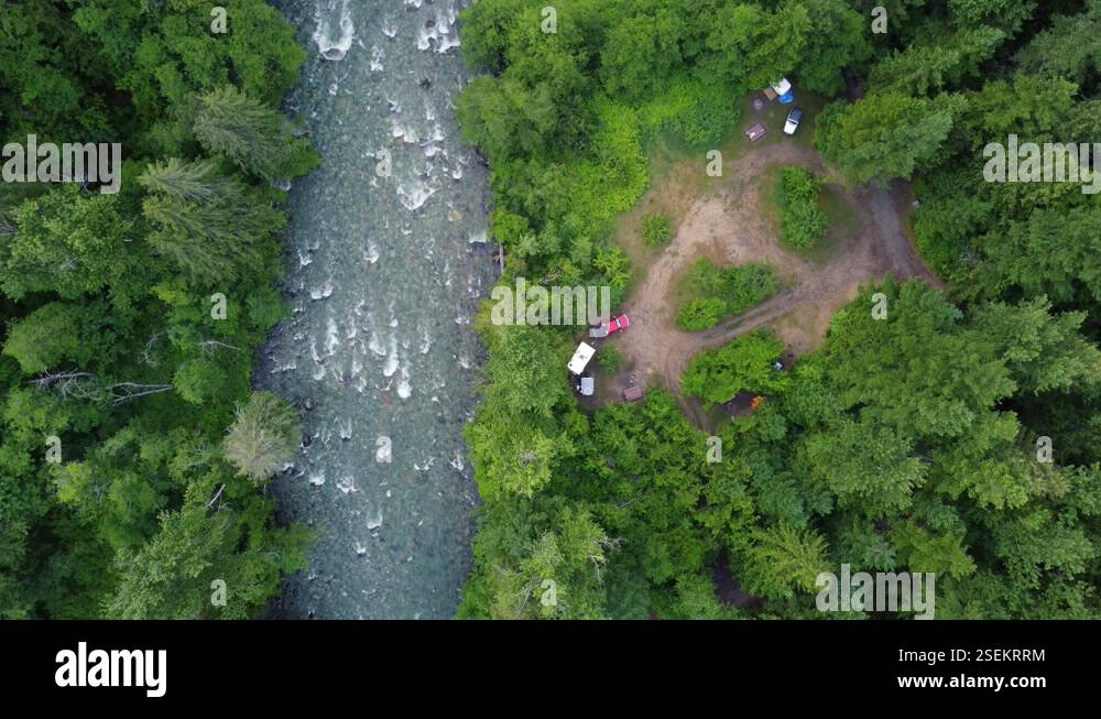 Top down view of the river near camping among the green spruce forest ...