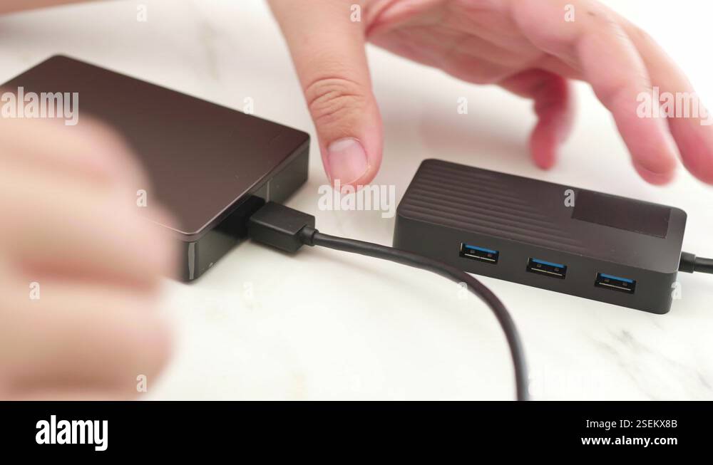 Man connect cable USB of the external hard disk to the hub for backup ...