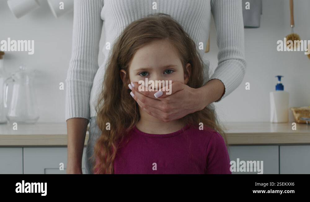 Secrets of family life. Portrait of scared little girl looking at ...