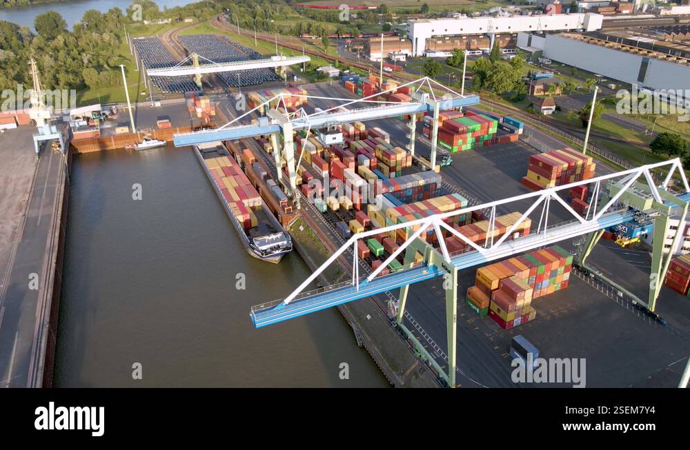 4K drone clip landing over shipping containers over a river and an ...