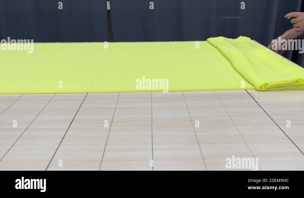 4k Male hands unrolling and cutting fabric in a textiles shop Stock ...