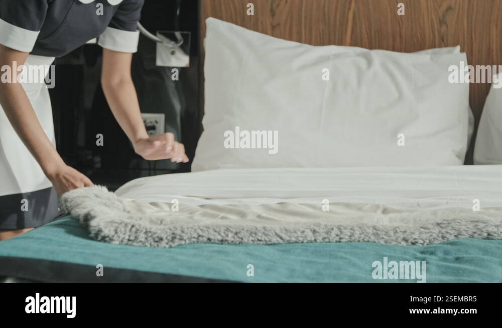 Female Housekeeper Making Bed in Hotel Room Stock Video Footage - Alamy