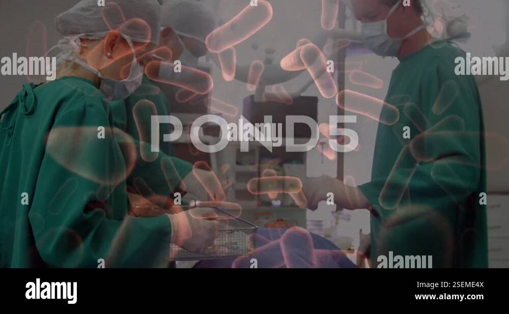 Multiple blood vessels floating against team of surgeons performing ...