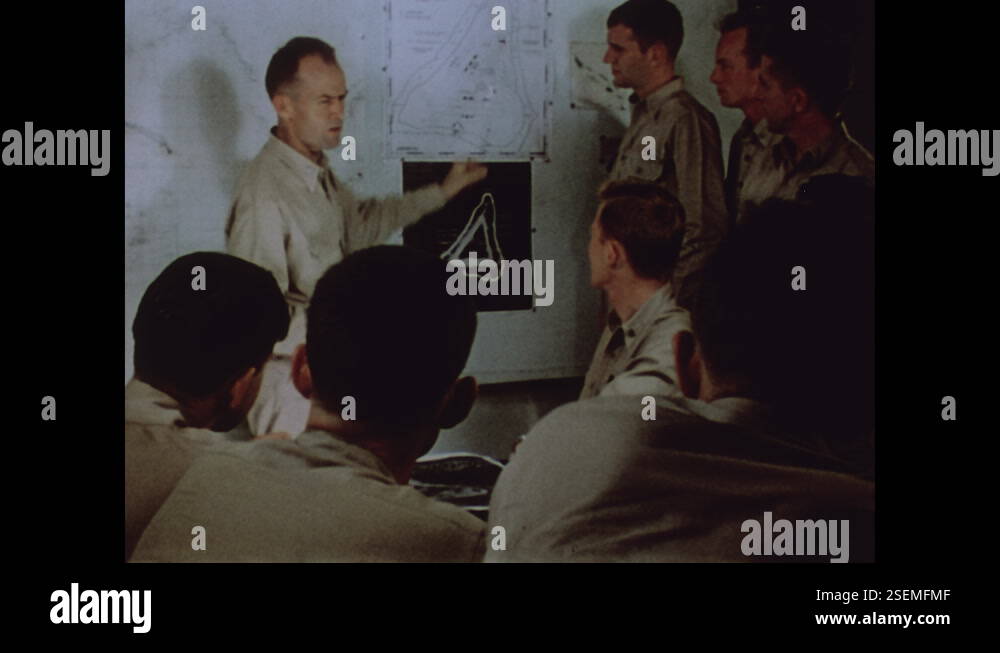 1940s: Commander instructions others with maps. Aerial photograph of an atoll Stock Video ...