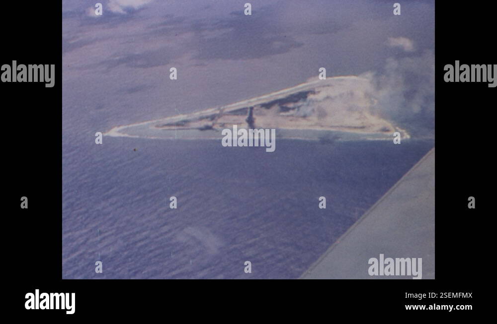Marcus Island 1940s: Overview of island after combat. Smoke rises from ...