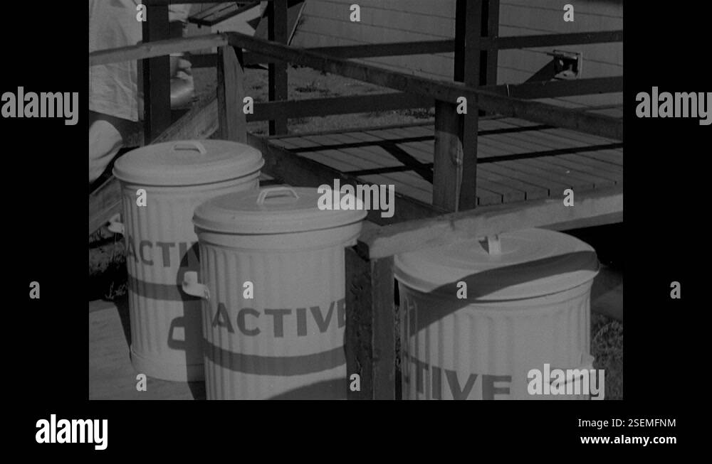 1940s: Three garbage cans. Two scientists walk by cans, enter building ...