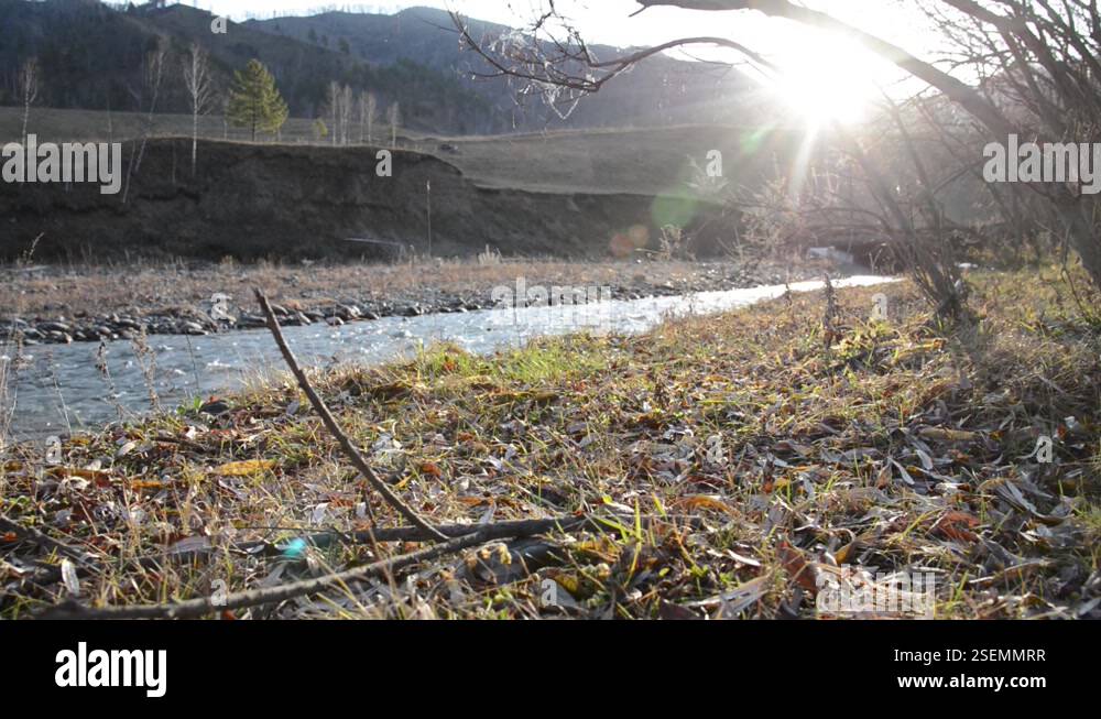 Dolly slider shot of the splashing water in a mountain river near ...