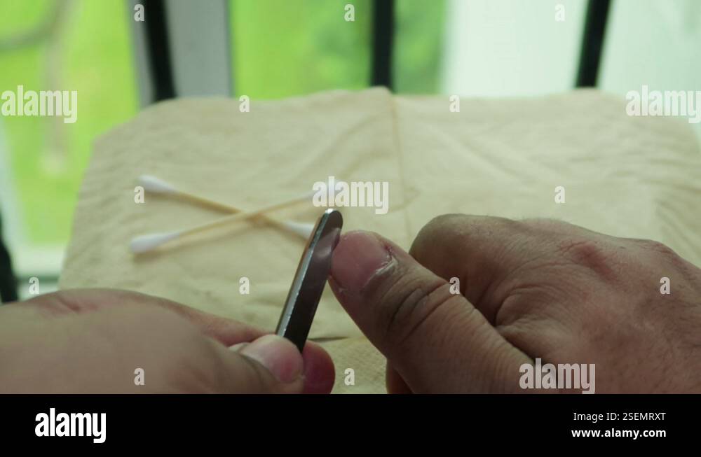This clip shows filing of a nail. Filing your nails is a good way to ...