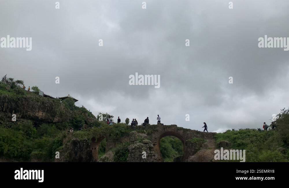 Bridge and hikers are enjoying the flooded river and waterfall in Debre ...