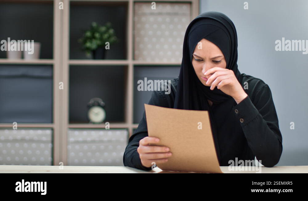 Upset Muslim woman crying read received paper letter having bad news ...