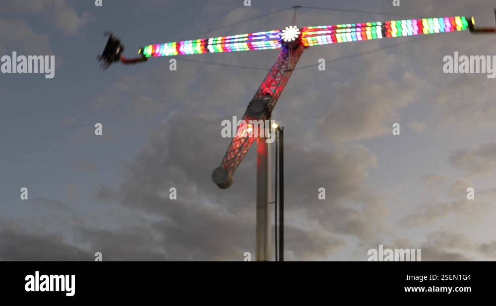 Carnival Ride tall spinning rotating arms with flashing neon lights ...