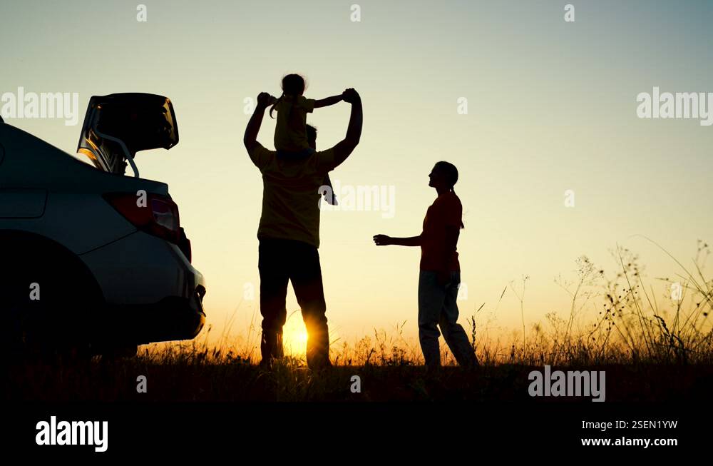 Parents and children stopped at campsite by car. Dad with child ...