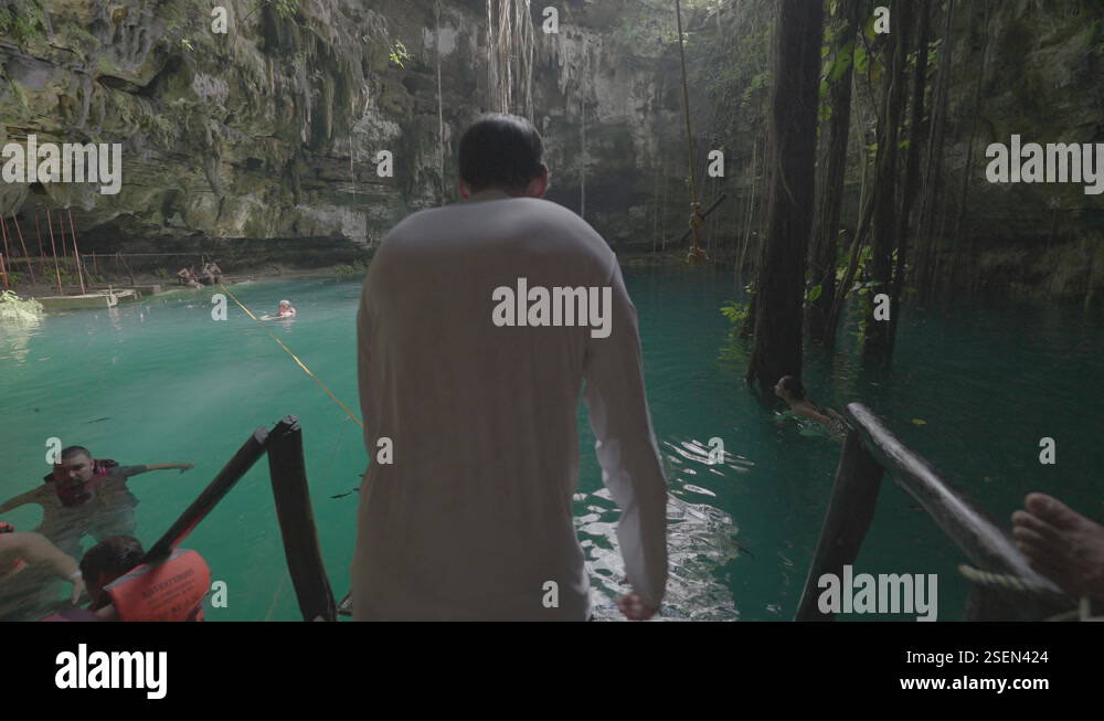 Back of a Man Jumping From Platform Into Turquoise Water of Mexican ...