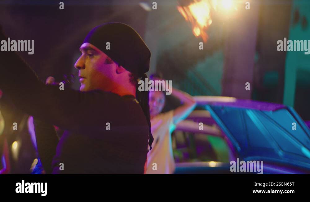 Man performing fire show with fire burning iron chain at night . Girls ...