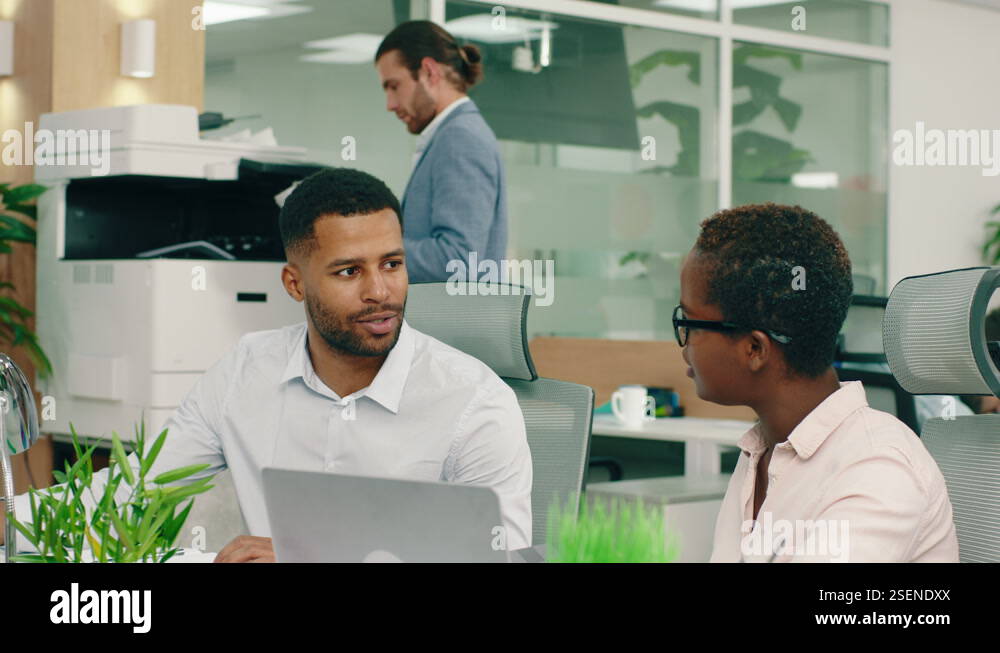 Two very good looking co- workers are in the office, having a ...