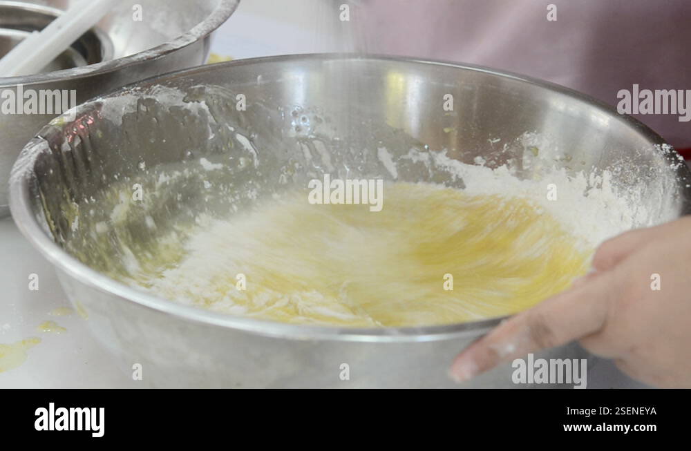 close up whisking butter , eggs and cream in bowl Stock Video Footage ...