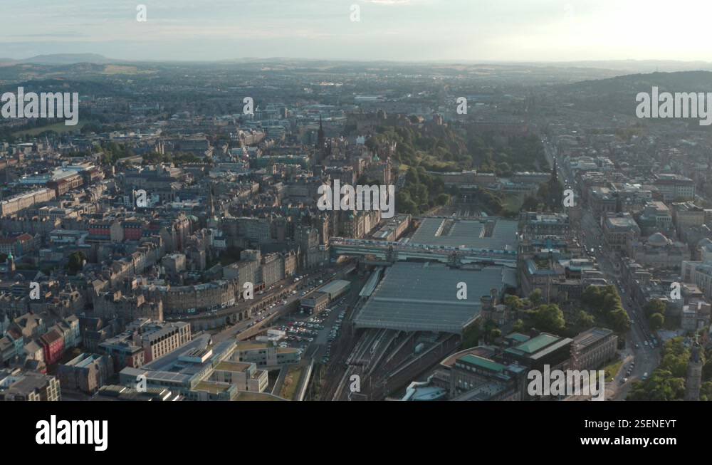 Slow dolly forward drone shot over Waverly towards Edinburgh castle ...