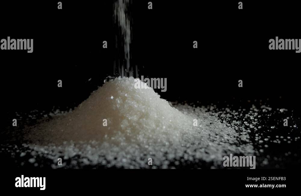 White sugar particles / crystals falling / dropped on a heap Stock ...
