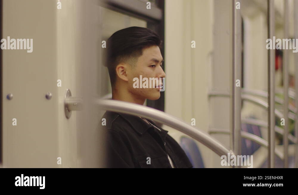Sad Young man sitting on a moving city metro train Stock Video Footage ...