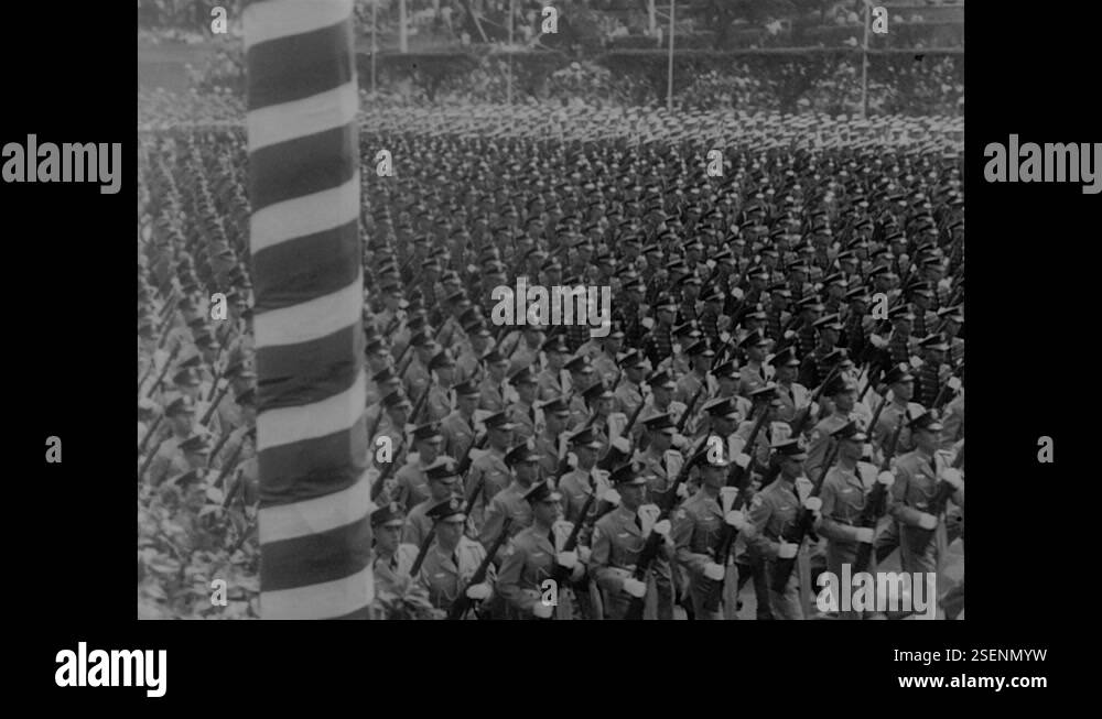 1960s: Chiang Kai-shek stands behind podium. Soldiers march in military ...