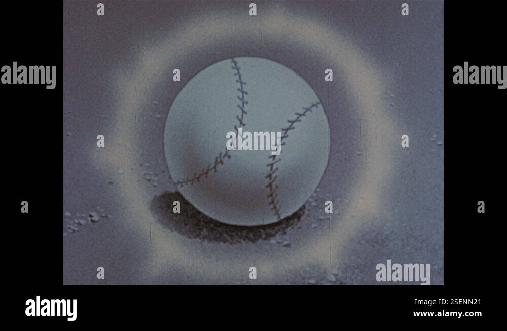 1950s: Baseball field in stadium. Baseball on field. Baseball radiates ...