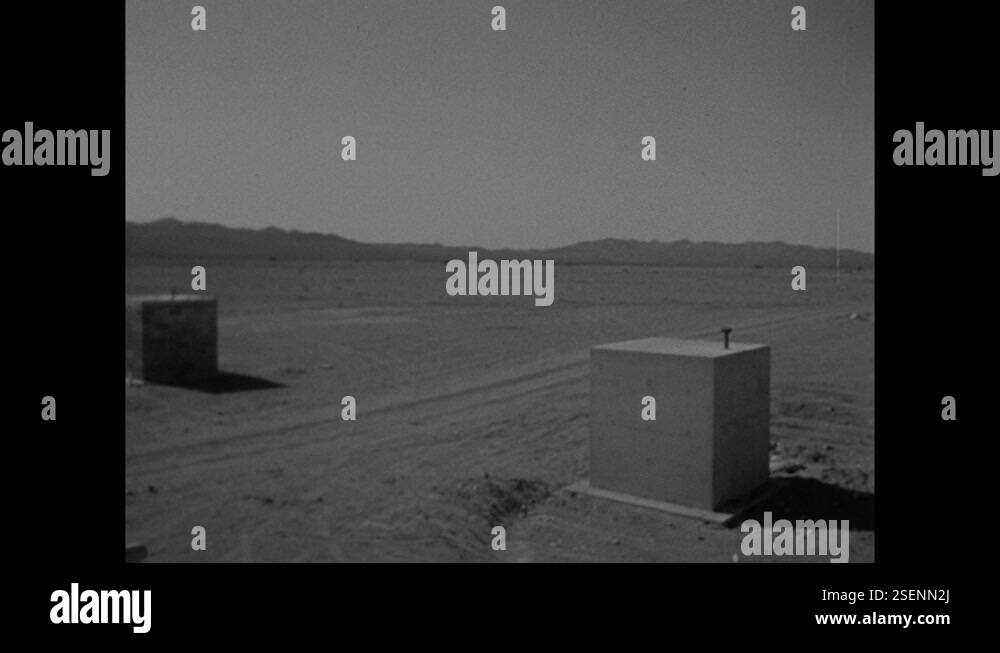 1960s: Two small concrete bunkers in the desert. Two bunkers hit with ...