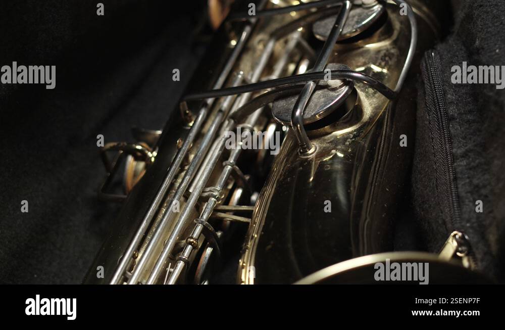 Saxophone lies in the dark, a close-up view of the keys. Saxophone ...