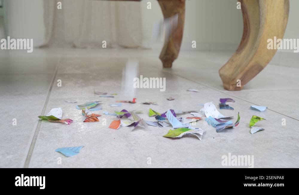 Coloured pieces of torn paper fall down on tile floor Stock Video ...