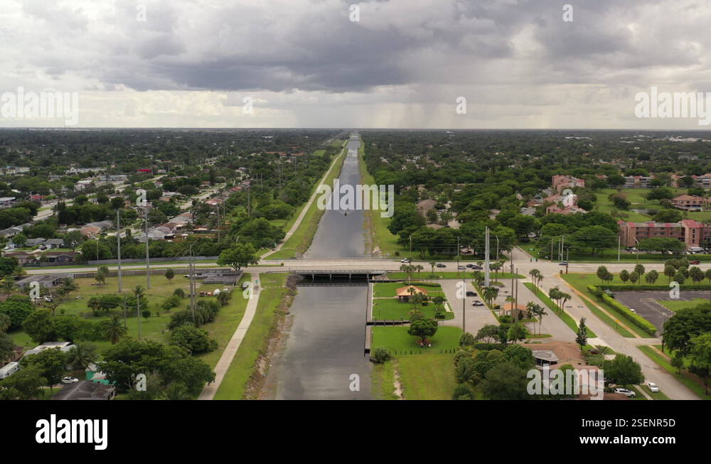 An aerial view of a long creek during the day. The camera dolly in over ...