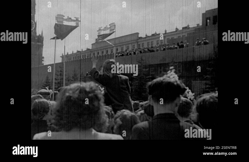 1940s: City. Joseph Stalin watches parade with dignitaries. Crowd holds ...
