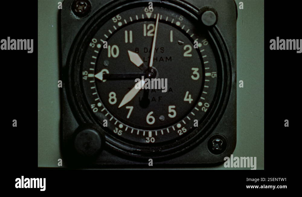 1960s: clock ticking, pilot wiping sweat off face, bomber flying in sky ...