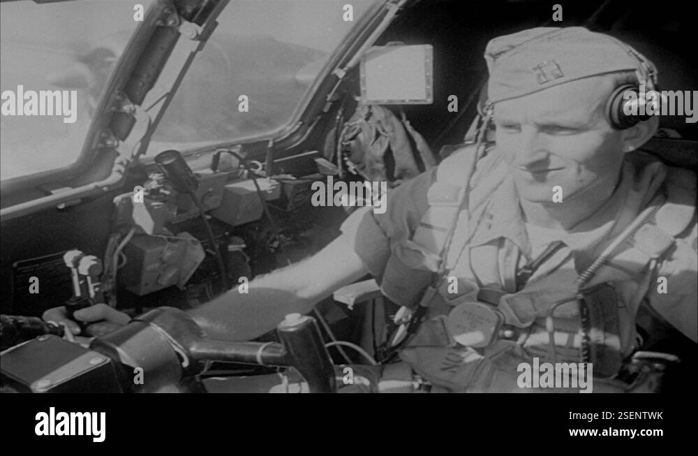 1940s: Pilot in cockpit of plane. Pilot speaks on mic and steers yoke ...