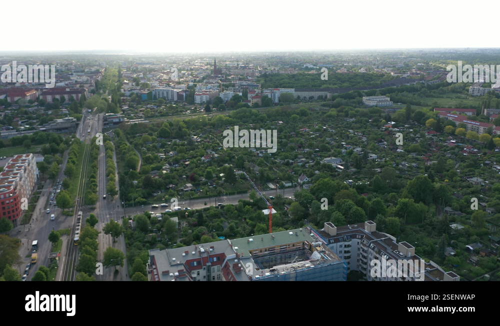 Fly above allotment gardens near Bosebrucke bridge. Small houses and ...