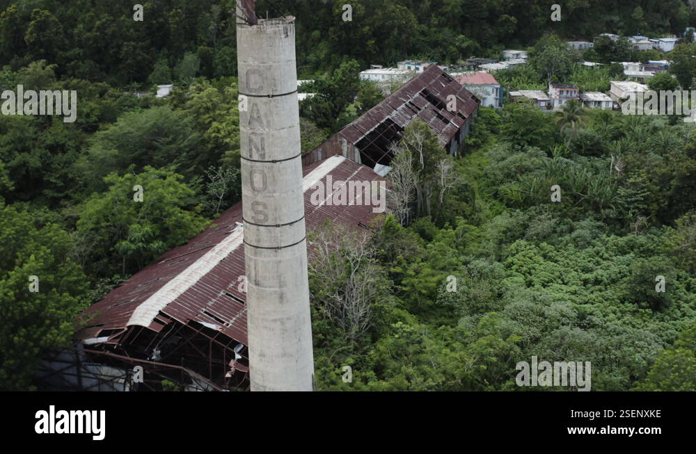 Aerial pull out over a long disused and now rusty factory building ...