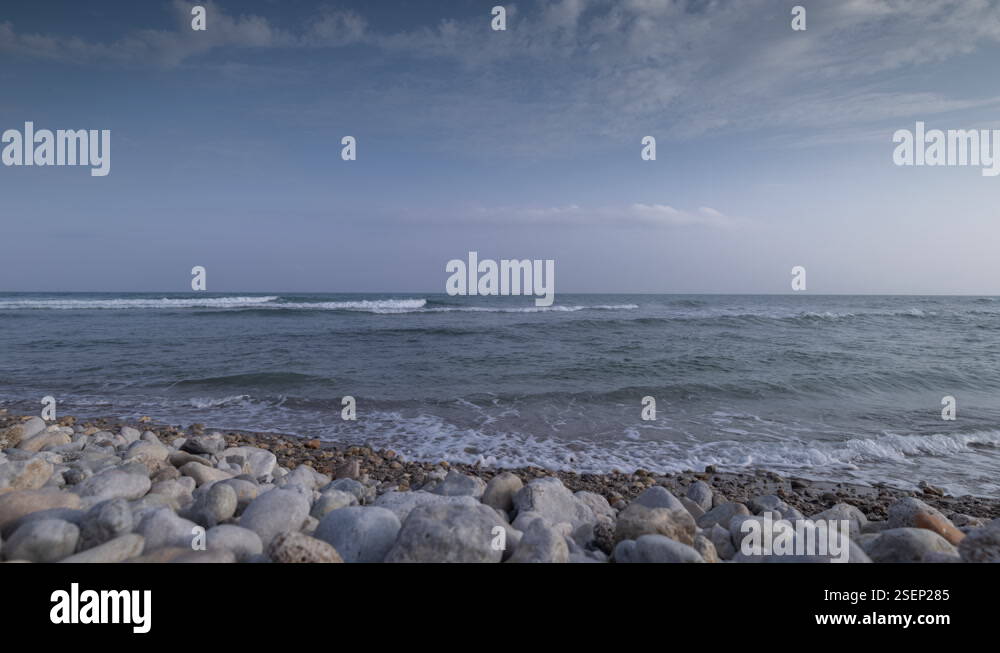 Pebble beach and tide coming in Stock Video Footage - Alamy