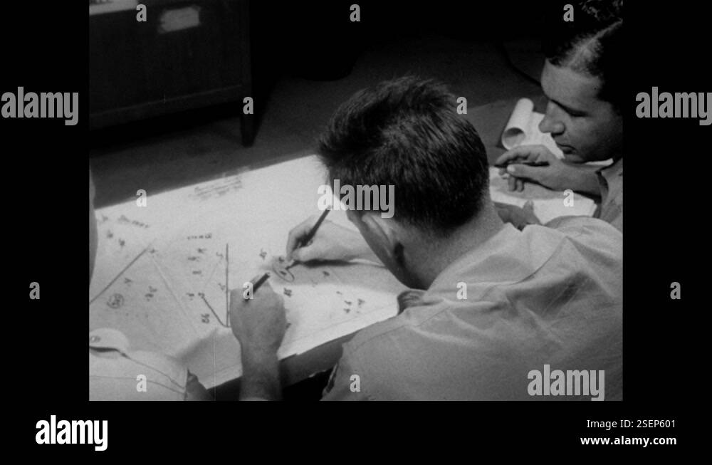 1940s: Military officers write on maps, charts. Officers looking at ...