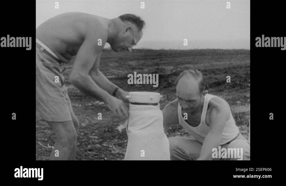 1940s: Two men set up equipment to record radiation levels during ...