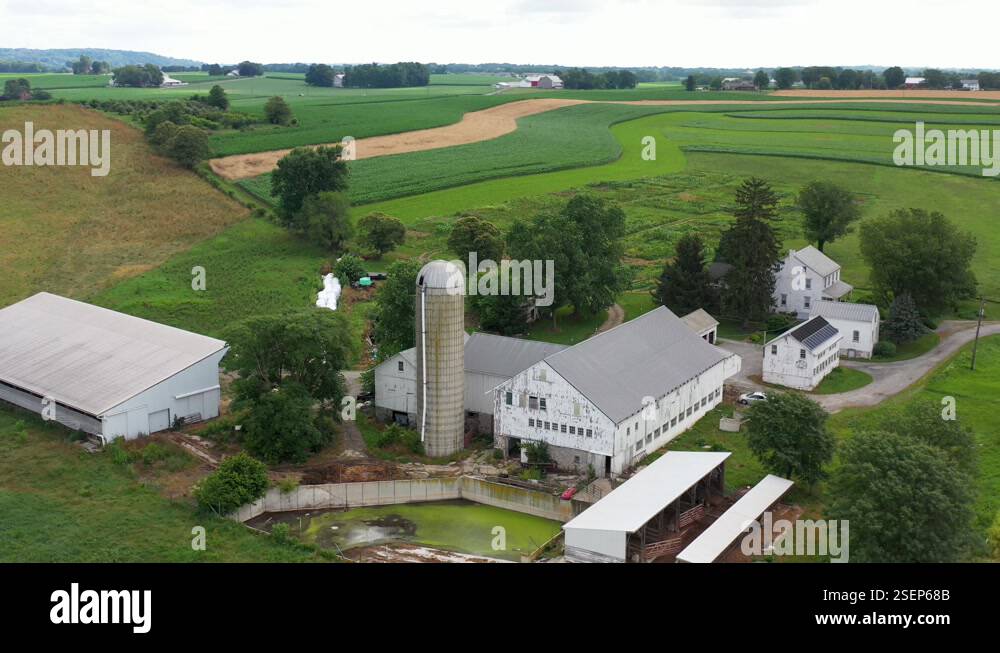 Orbit of farm with rundown buildings, waste water runoff. Polluted ...