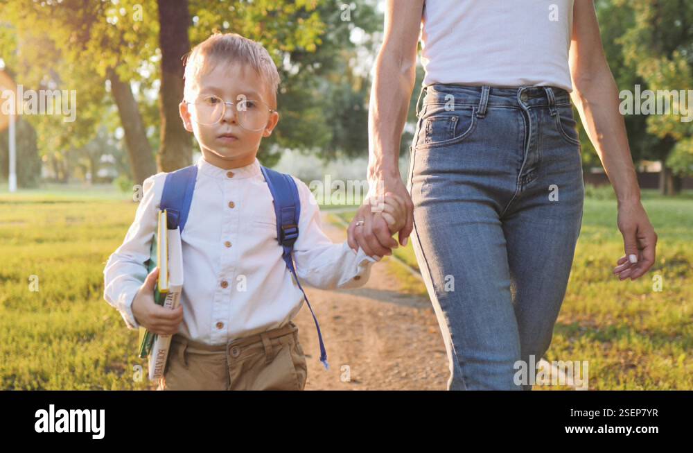 First time to school. Happy cute clever boy in glasses with school bag ...