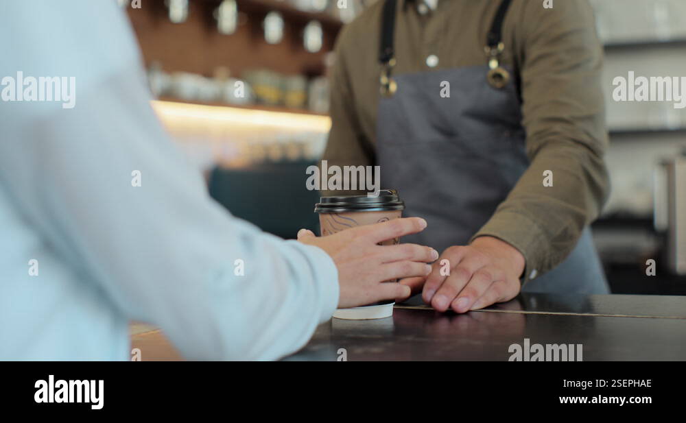 Close up of hands of barista man and client woman. Barista handing ...