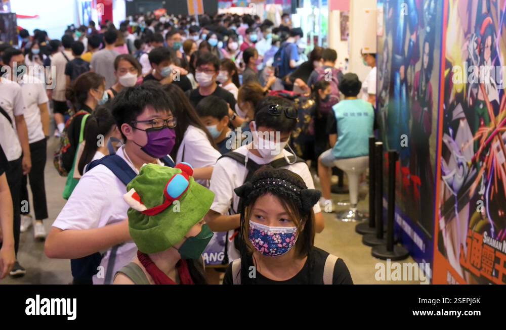 Visitors queue in line to have access to a booth during the Anicom and ...