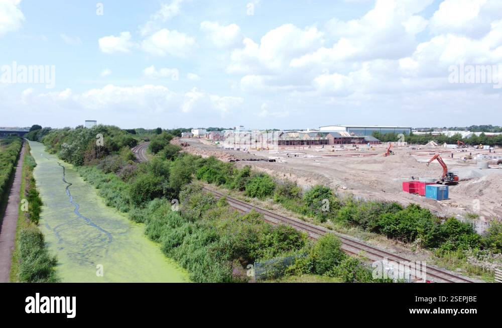 Idyllic green algae covered canal alongside housing development ...