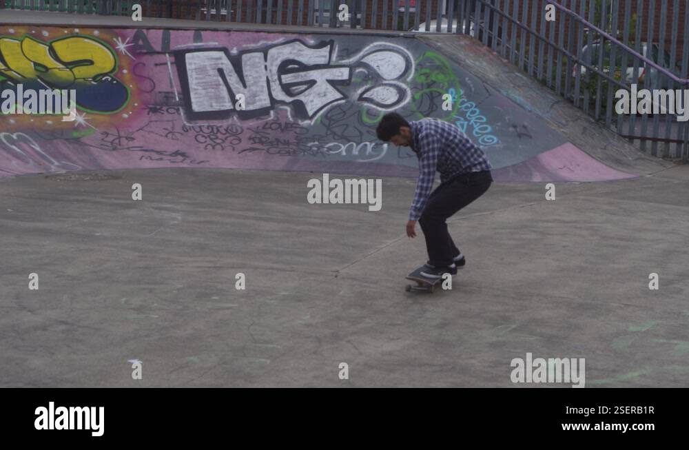 Slow-mo of skate boarder jumping at a skate park in Sheffield, England ...