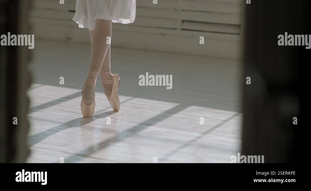 Ballerina standing on tip-toes. Ballet dancer wearing pointe shoes ...