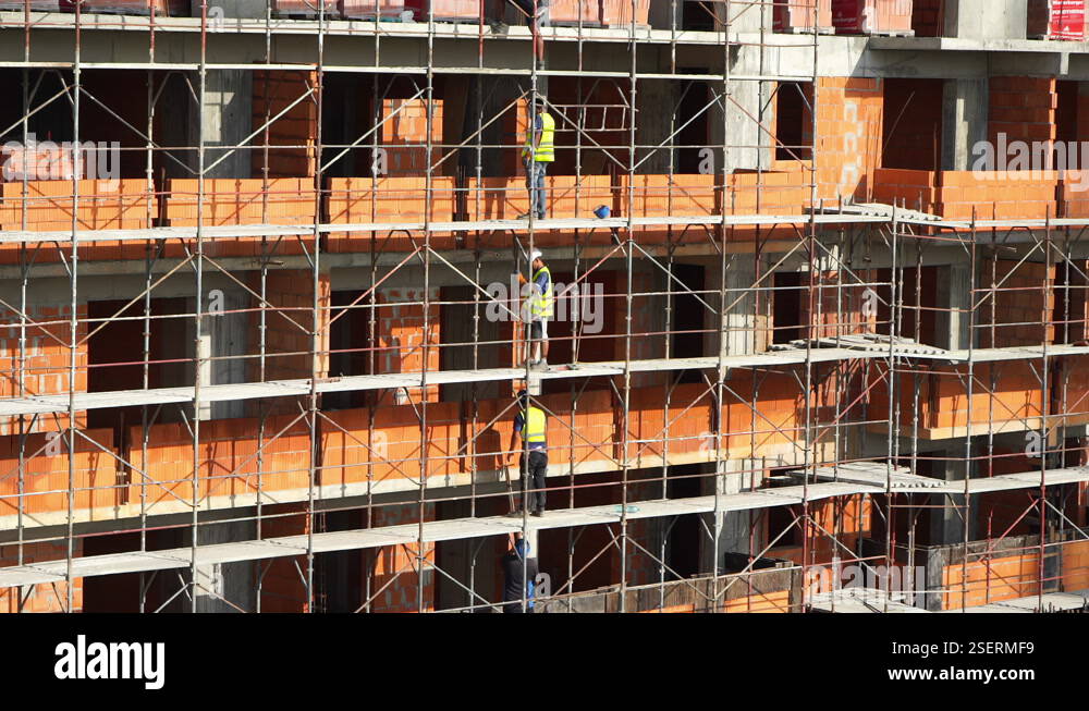 Construction workers team work on scaffolding Stock Video Footage - Alamy