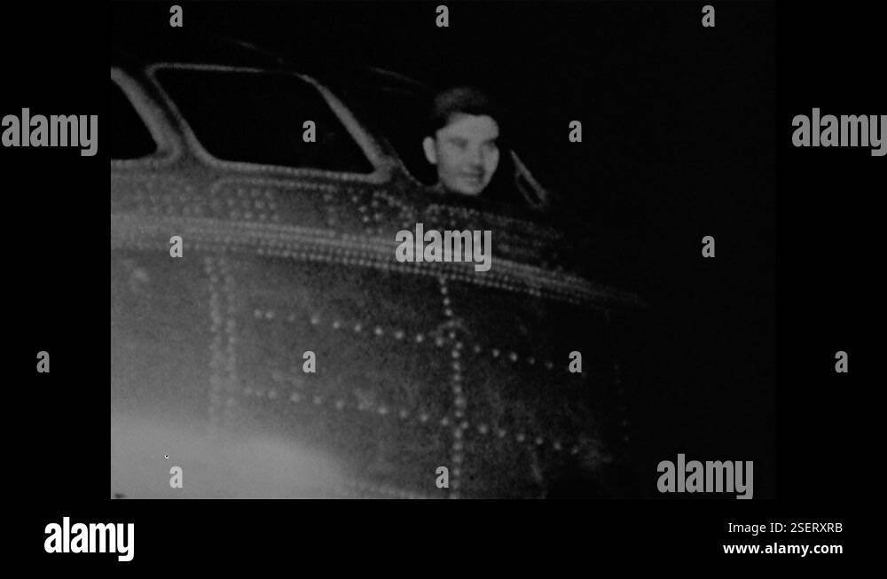 1940s: Hatch on plane closes. Man sticks head out airplane window ...