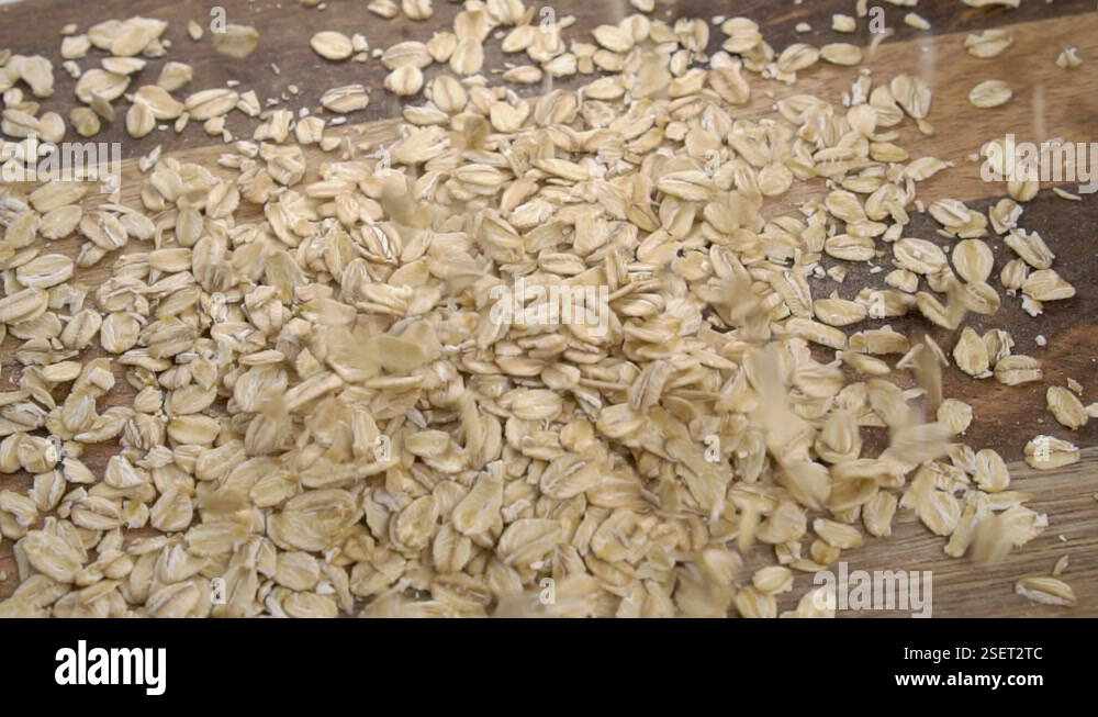 Dry oatmeal cereal grain flakes falling in a heap Stock Video Footage ...
