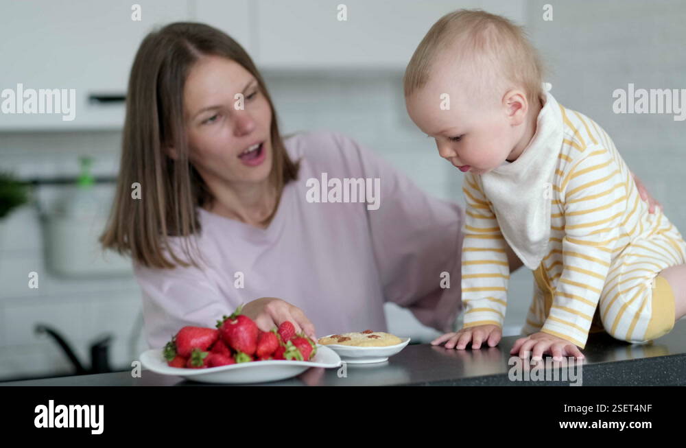 Mother and baby cooking on kitchen at home. Healthy food, lunch time ...