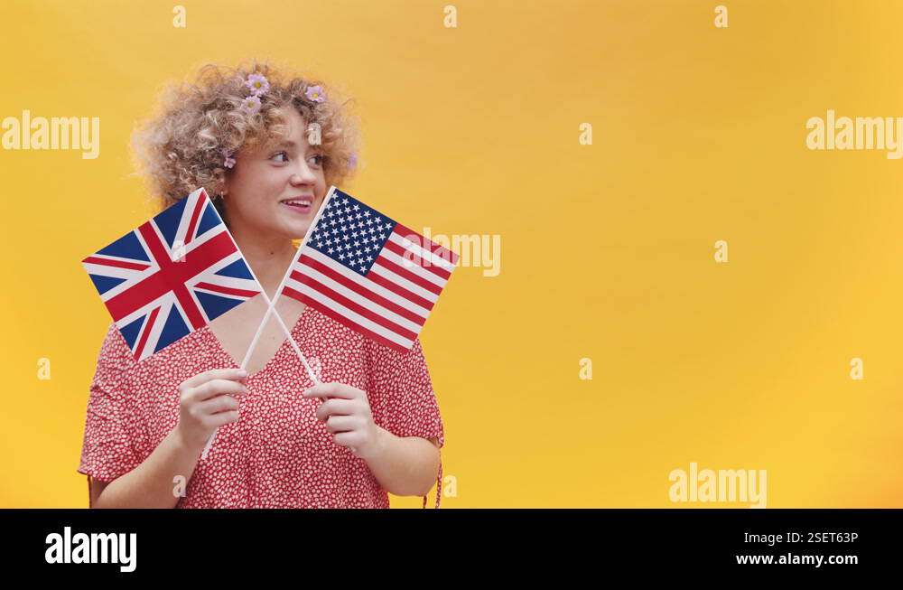 Young woman with curly hair holding USA and UK flag Stock Video Footage ...